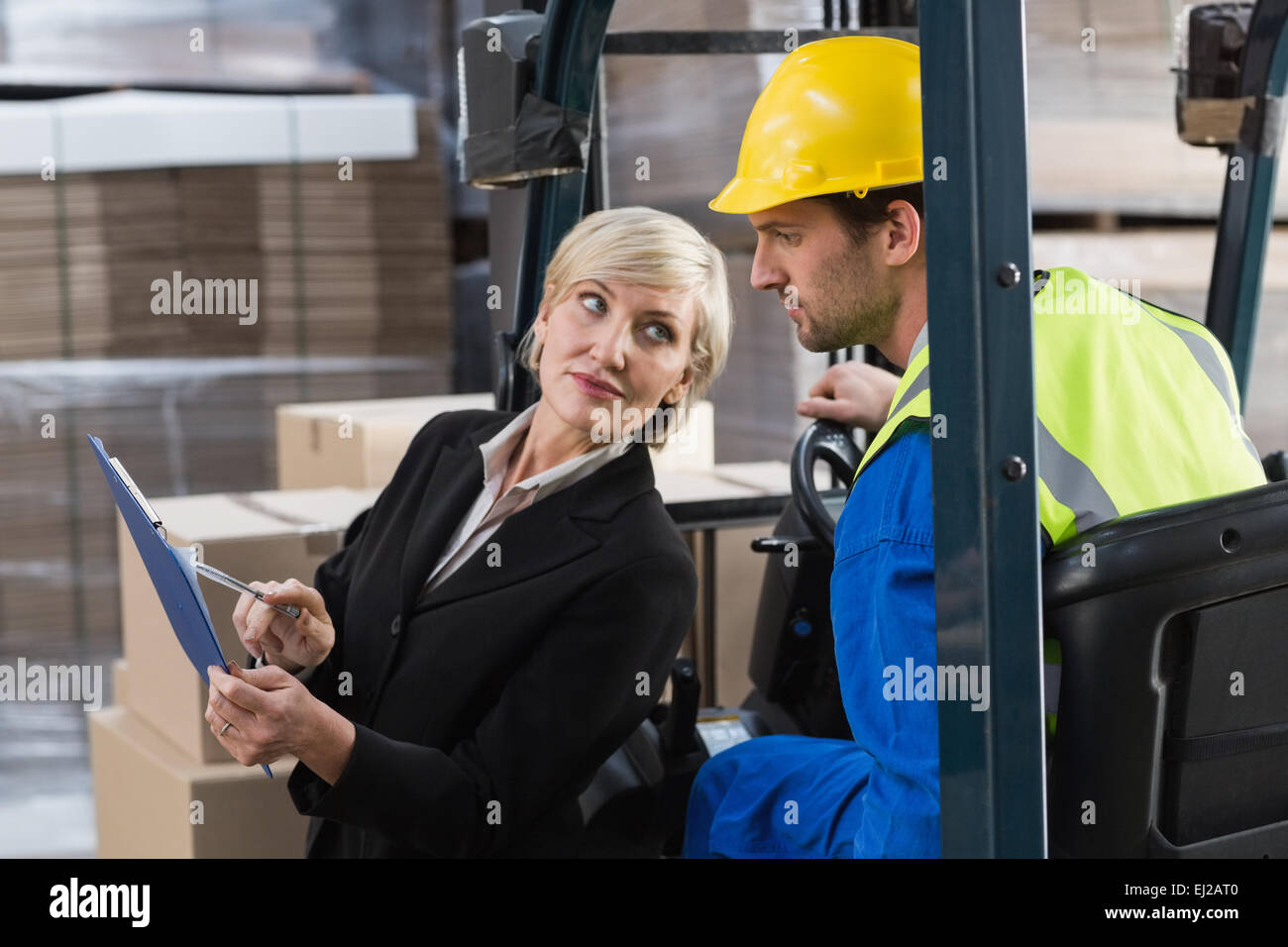 Warehouse management talking forklift driver hi-res stock photography ...