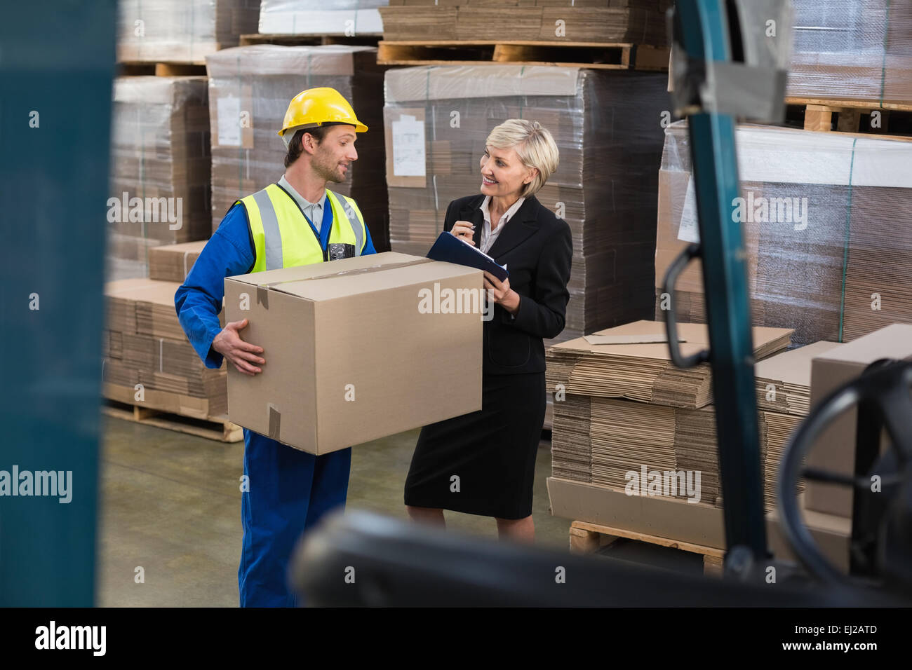 Warehouse worker and his manager working together Stock Photo - Alamy