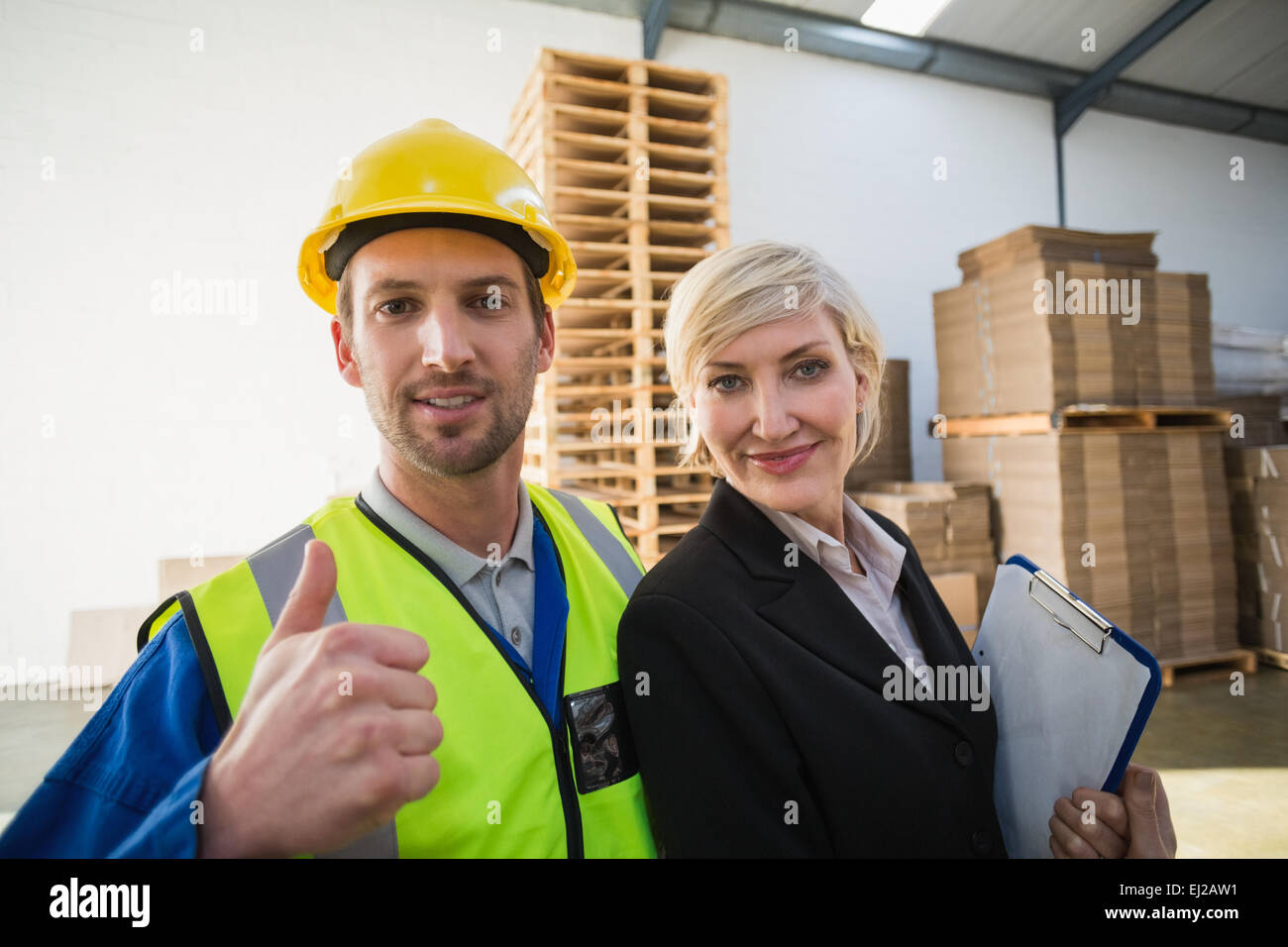 Portrait of smiling warehouse worker and his manager Stock Photo - Alamy