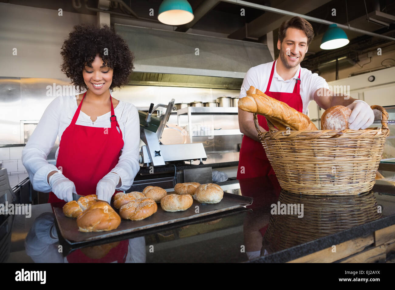 Smiling servers standing behind the counter Stock Photo - Alamy