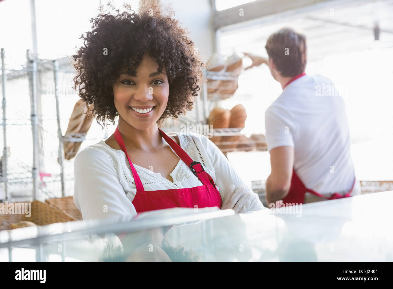 Pretty waitress posing with arms crossed Stock Photo - Alamy