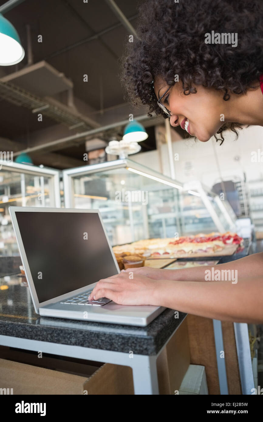 Owner using laptop counter hi-res stock photography and images - Alamy