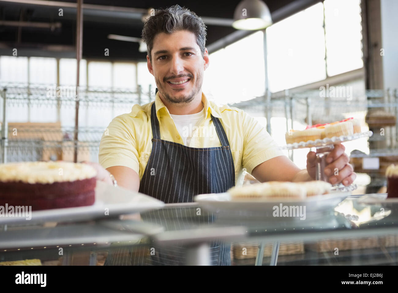 Attractive worker in apron posing Stock Photo - Alamy