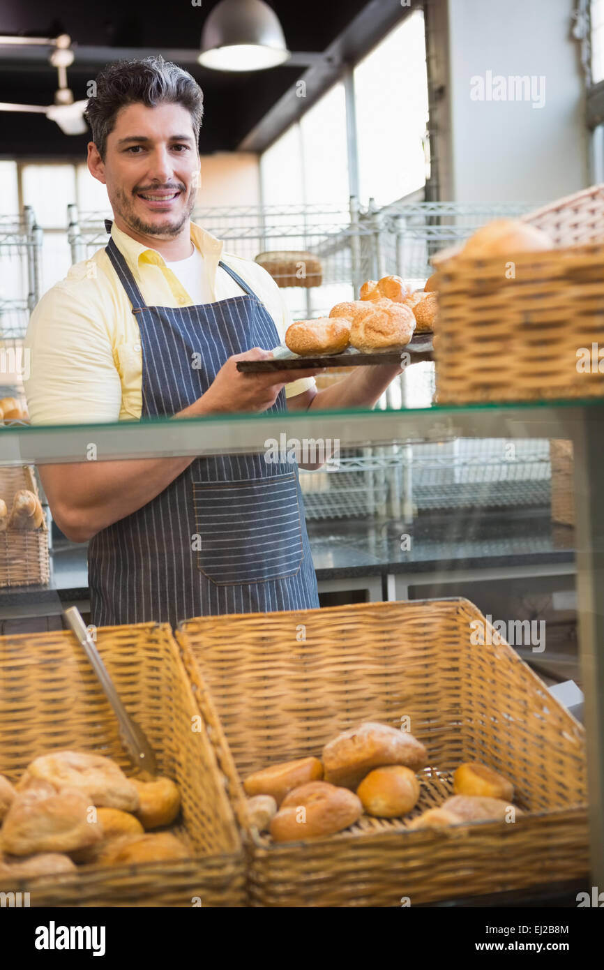Smiling waiter showing tray of breads Stock Photo - Alamy