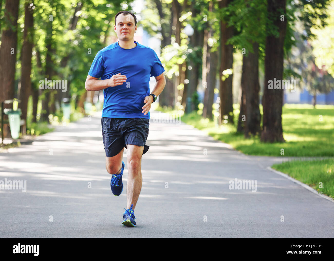 Young man running outdoors in the morning Stock Photo - Alamy