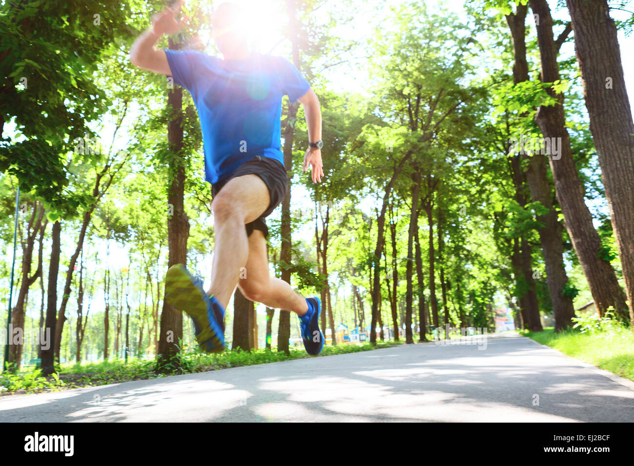 Young man running outdoors in the morning Stock Photo - Alamy