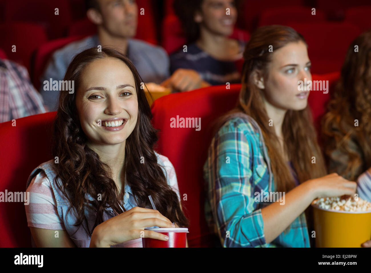 Young friends watching a film Stock Photo - Alamy