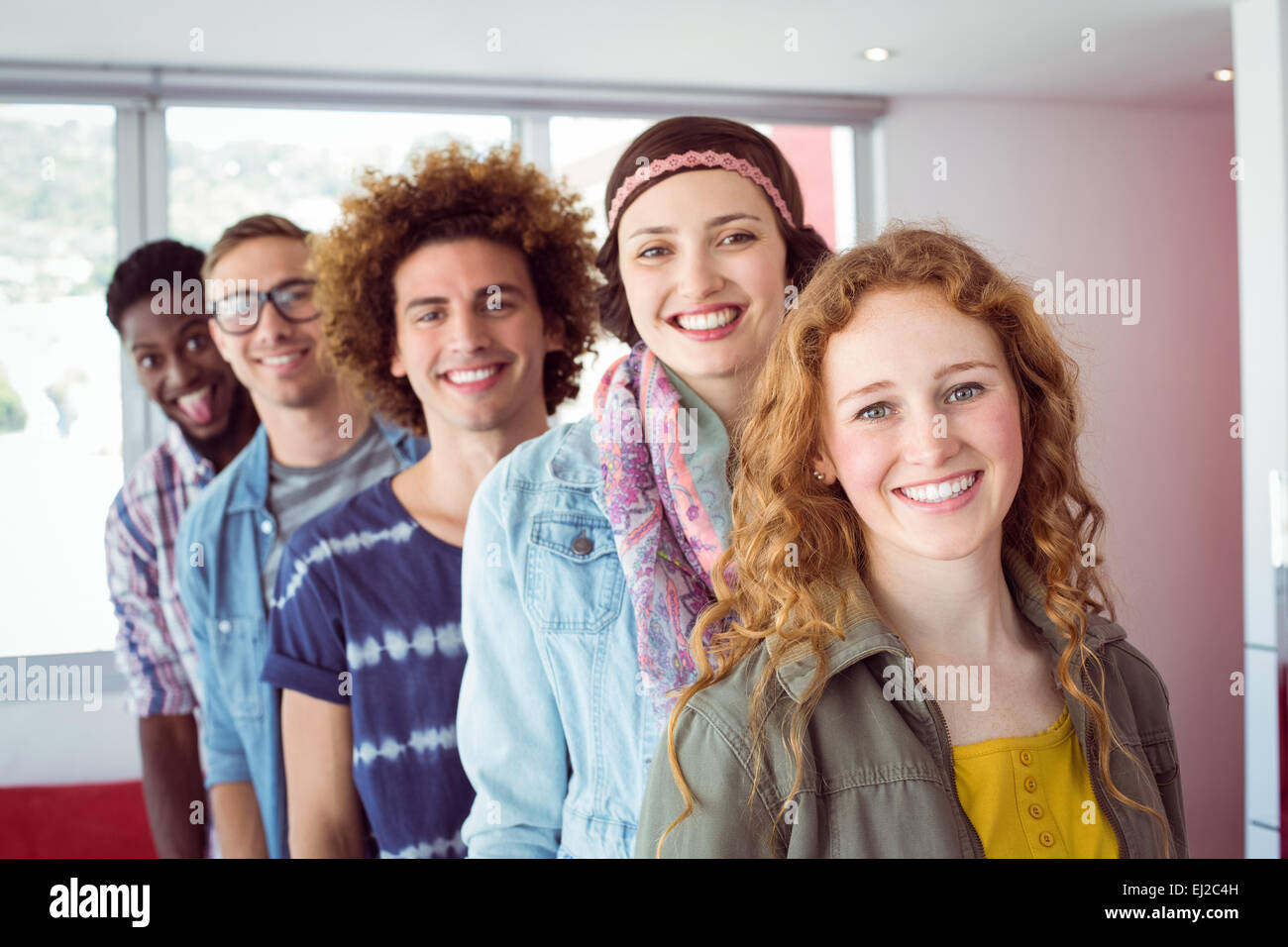 Fashion students smiling in a single line Stock Photo - Alamy