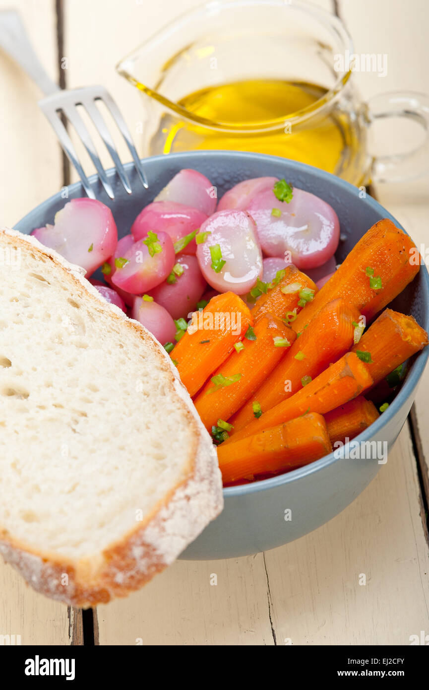 bowl of steamed root vegetable on a rustic white wood table Stock Photo ...