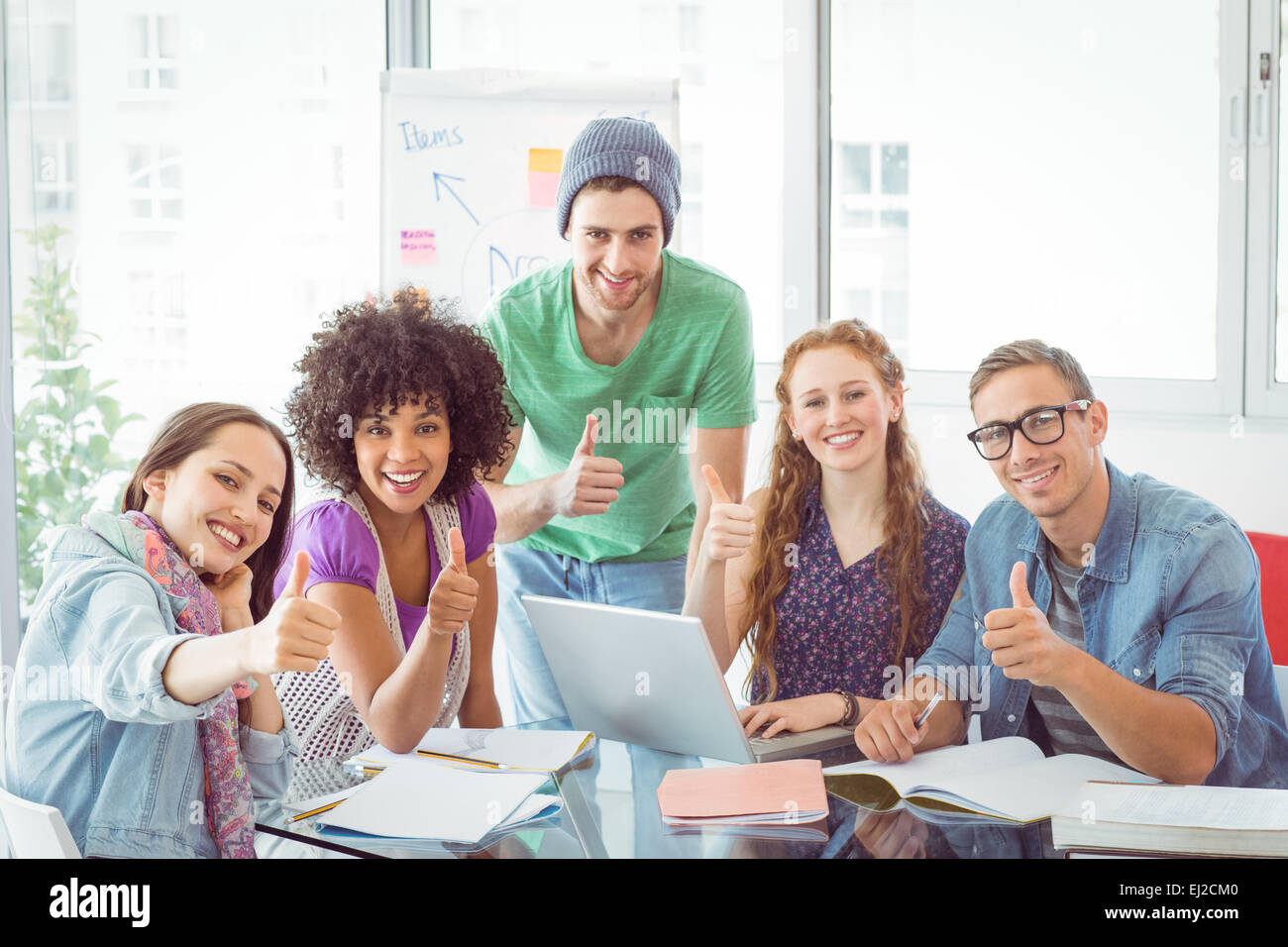 Fashion students smiling at camera together Stock Photo - Alamy
