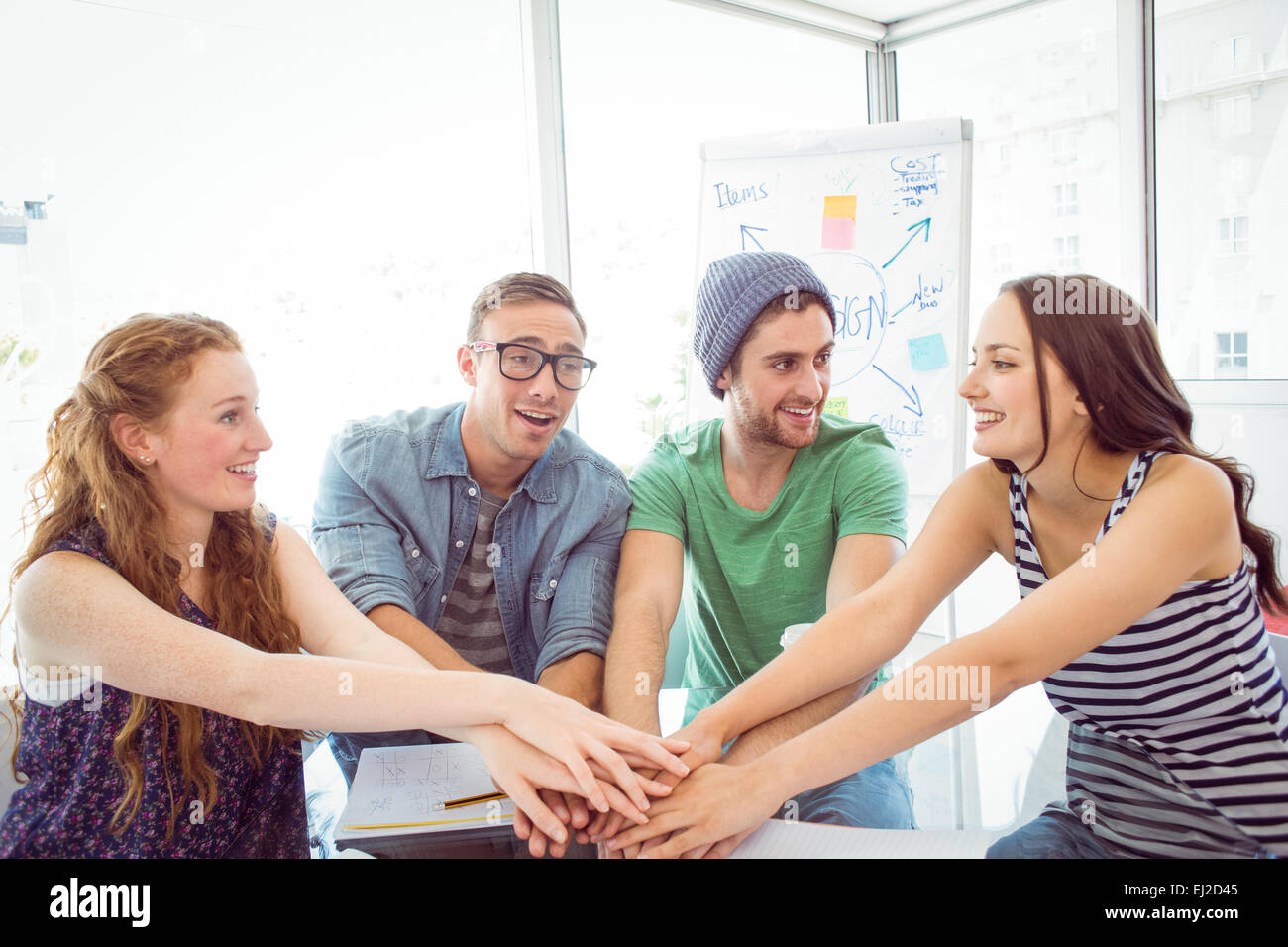 Fashion students high fiving together Stock Photo - Alamy