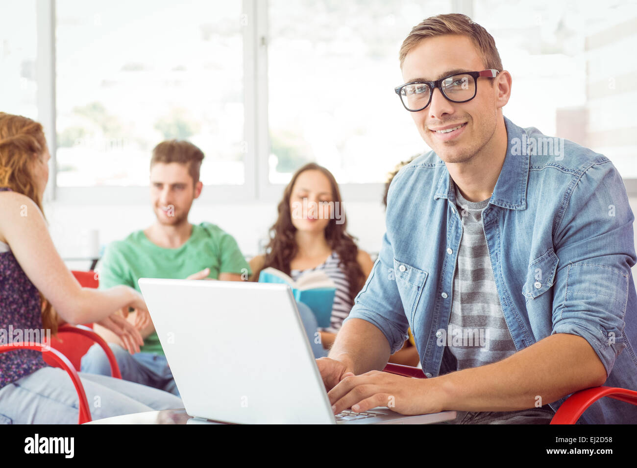 Fashion student using his laptop Stock Photo - Alamy