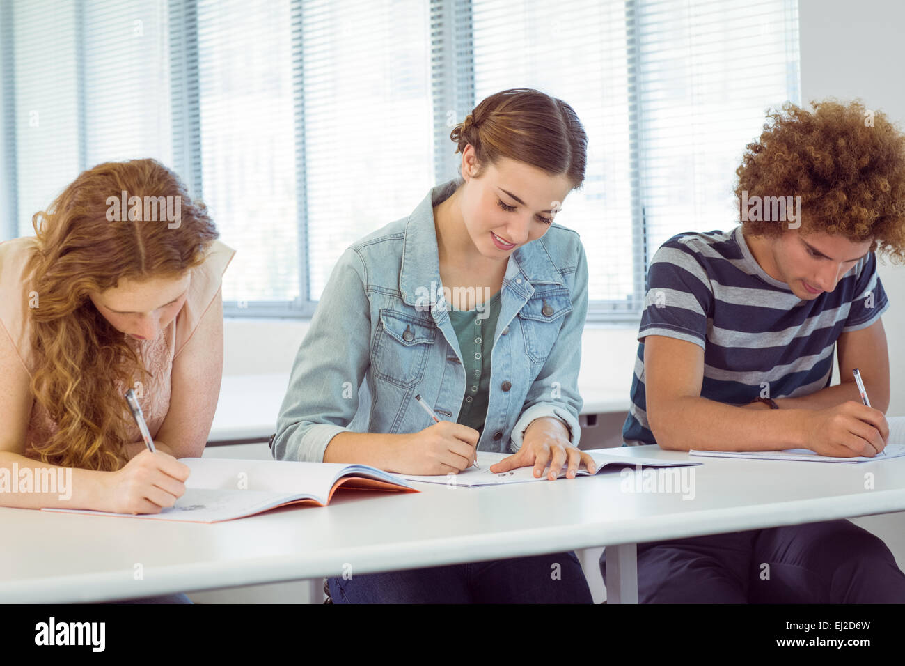 Fashion students taking notes in class Stock Photo - Alamy