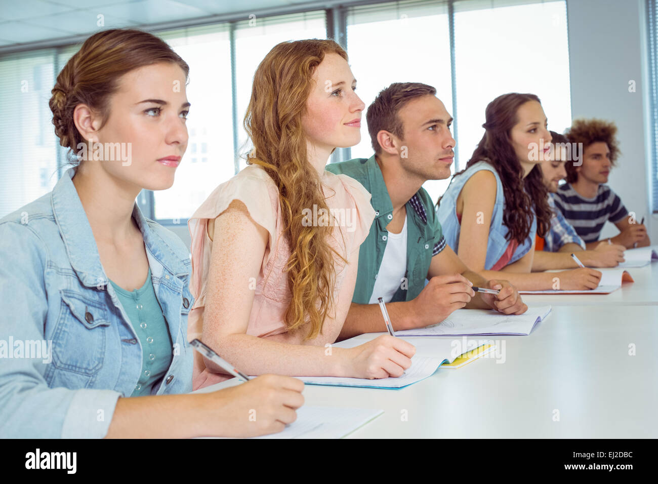 Fashion students taking notes in class Stock Photo - Alamy