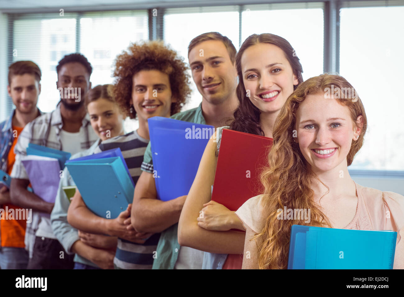 Fashion students smiling at camera together Stock Photo - Alamy