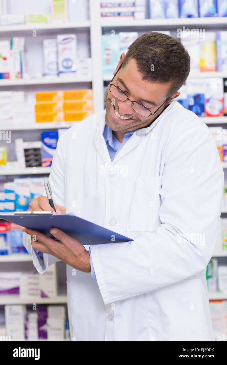 Happy pharmacist on the phone Stock Photo - Alamy