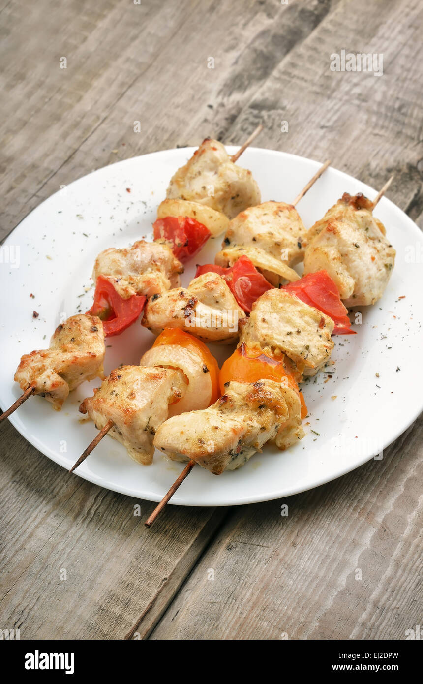 Chicken shish kebab on wooden table Stock Photo - Alamy