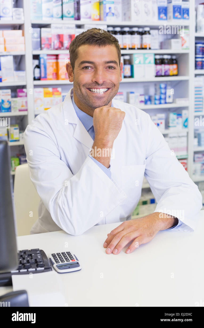 Happy pharmacist using the computer Stock Photo - Alamy