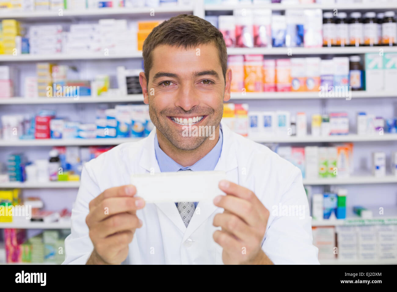 Handsome pharmacist holding paper Stock Photo - Alamy