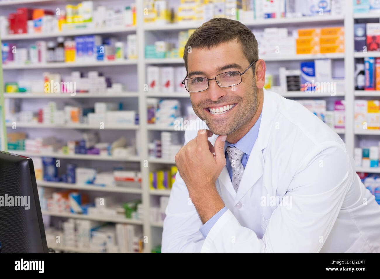 Smiling pharmacist looking at camera Stock Photo - Alamy