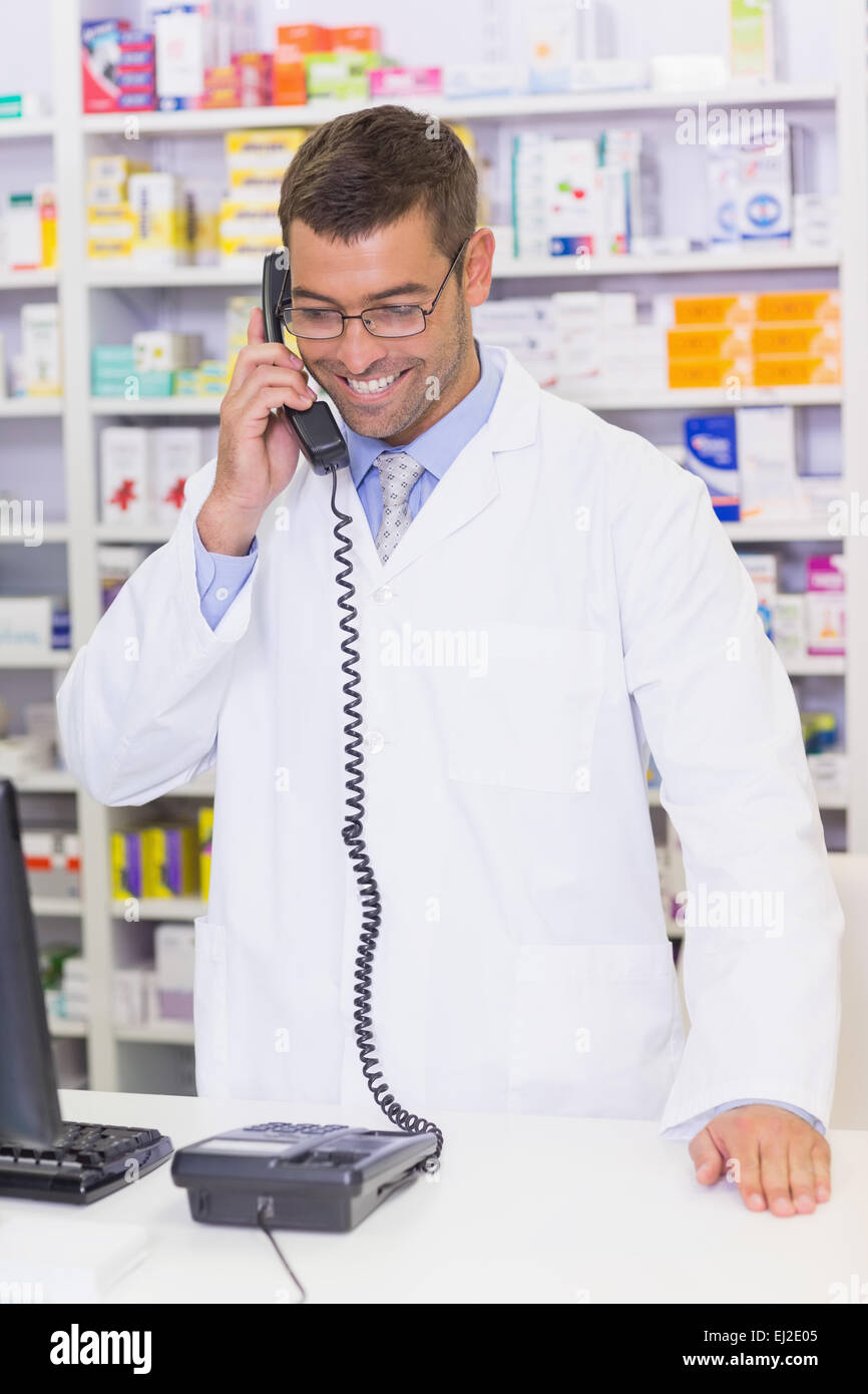 Happy pharmacist on the phone Stock Photo - Alamy