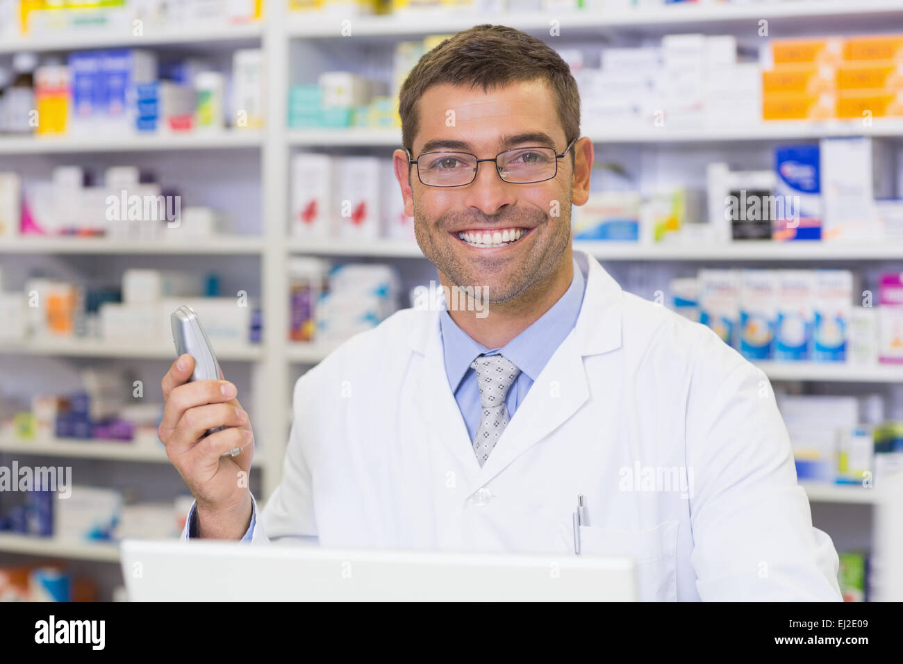 Happy pharmacist on the phone Stock Photo - Alamy