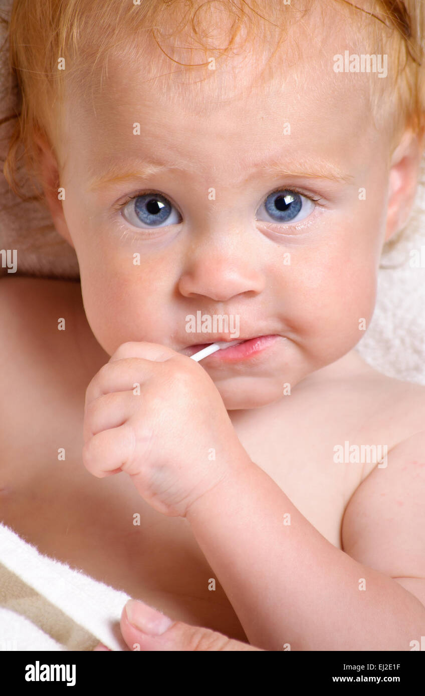 Cute little baby playing with cotton stick Stock Photo - Alamy
