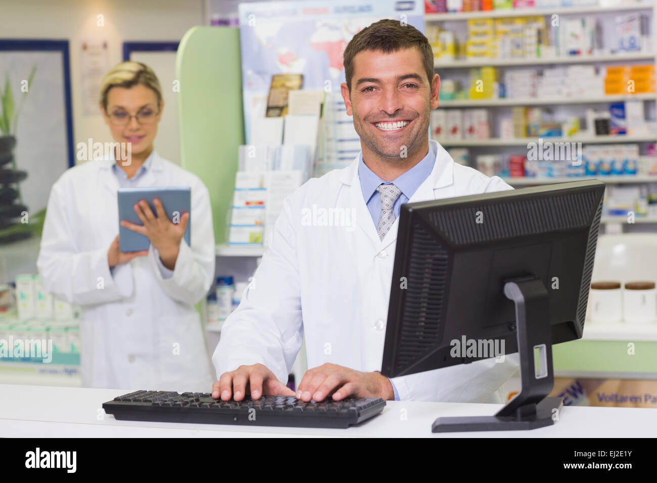 Happy pharmacist using computer hi-res stock photography and images - Alamy