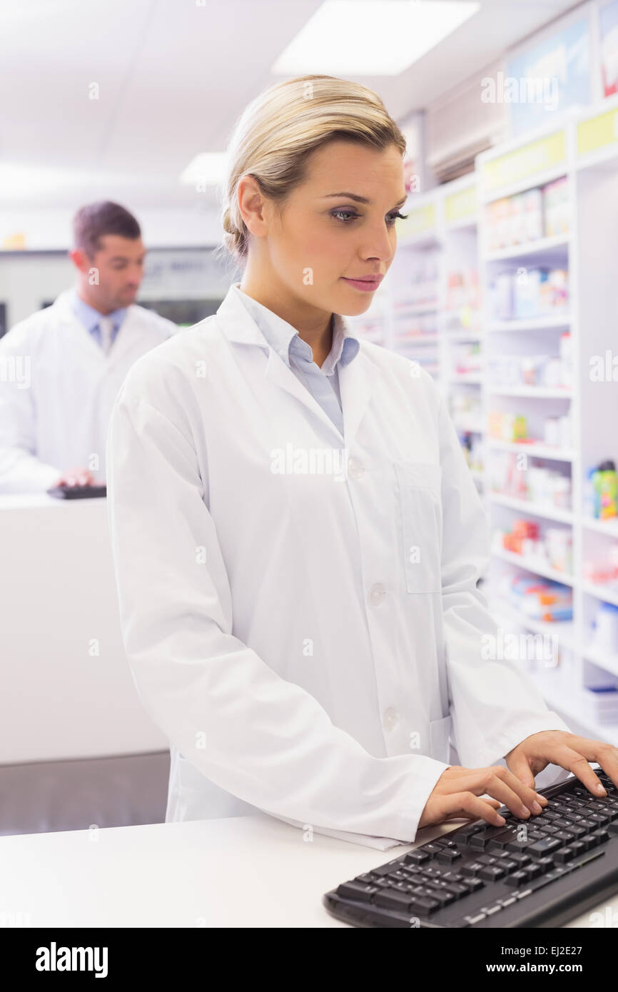 Concentrate pharmacist using computer Stock Photo - Alamy