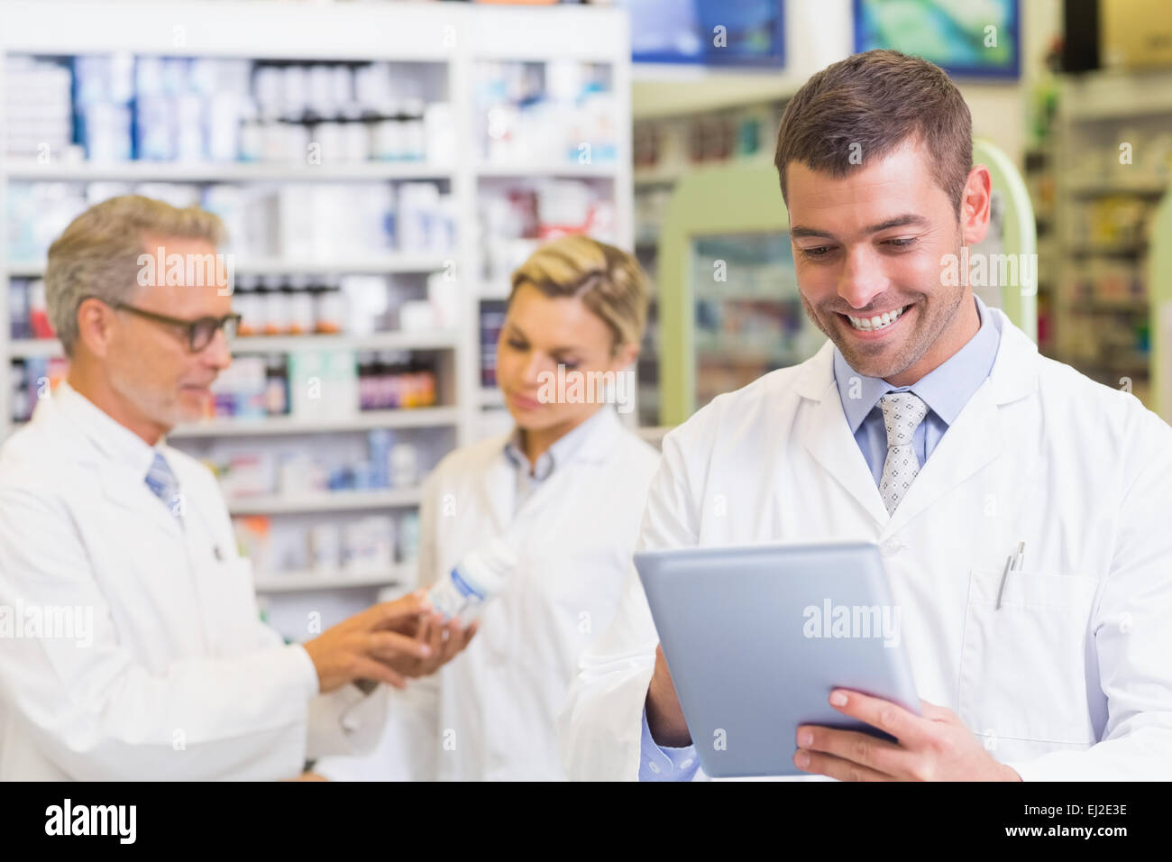 Pharmacist using the tablet Stock Photo - Alamy