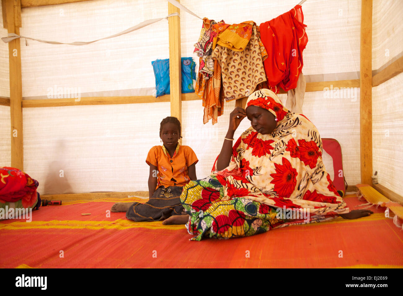 Eyande Ali (30) and her daughter Aisha (6) sit in a tent in a refugee ...