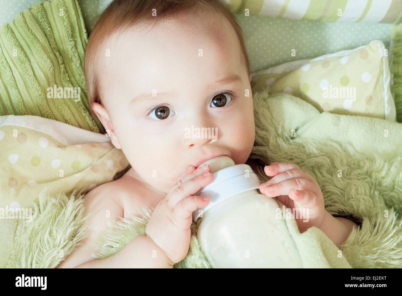 Funny little baby with beautiful standing in a round white crib Stock ...