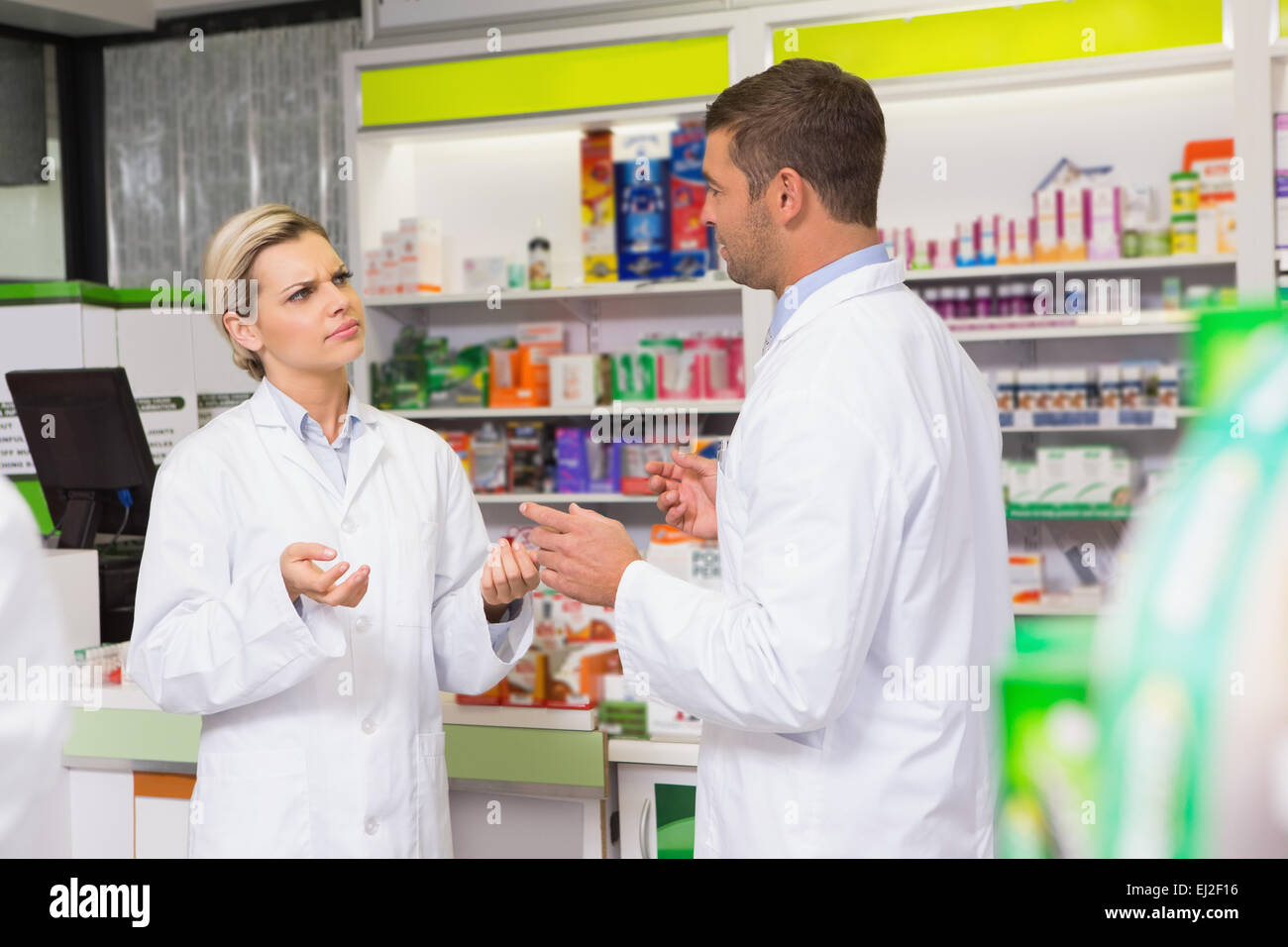 Team of pharmacist talking together Stock Photo - Alamy