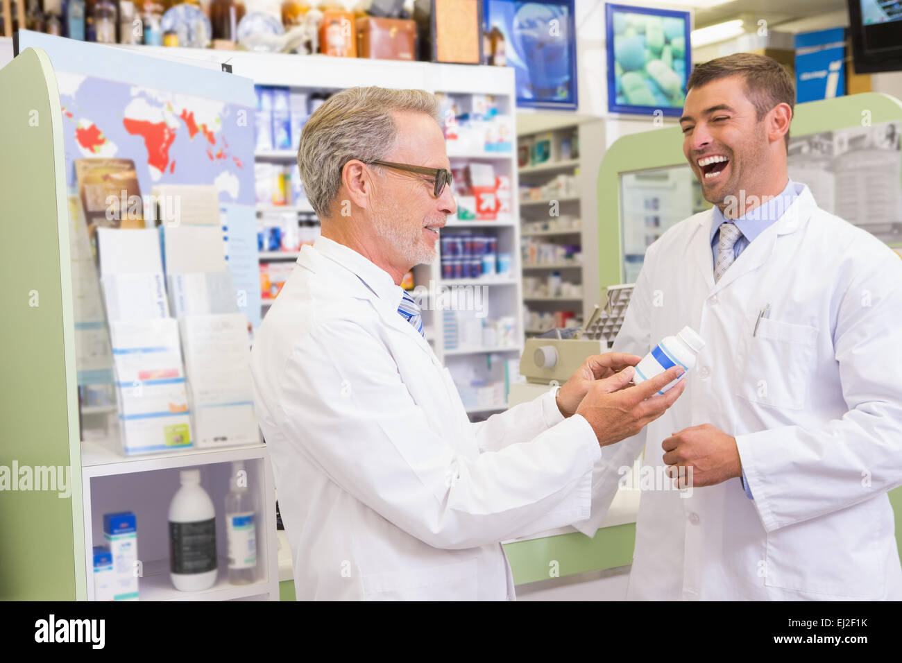 Smiling pharmacists holding medication Stock Photo - Alamy