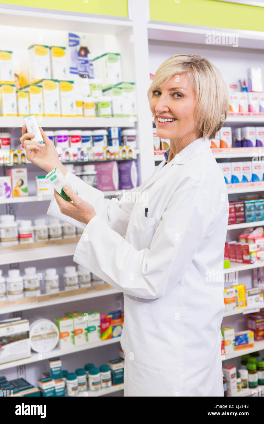 Smiling pharmacist holding boxes of medicine Stock Photo - Alamy