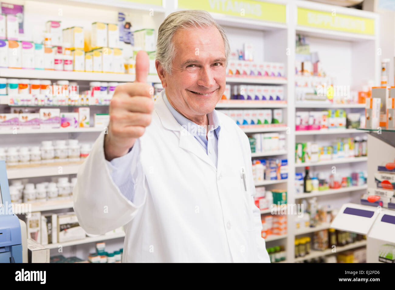 Positive pharmacist with thumb up Stock Photo - Alamy