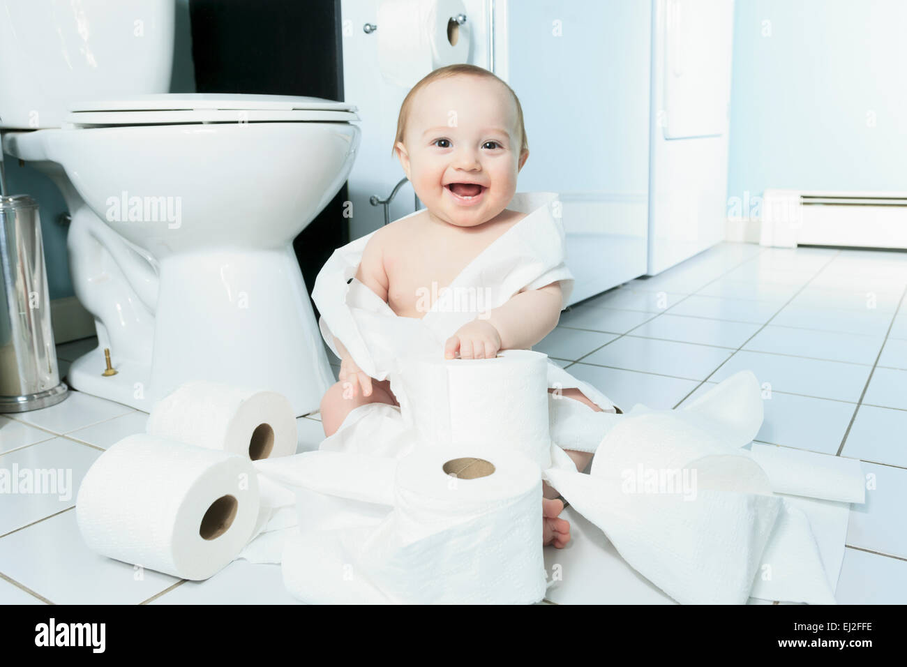 Toddler ripping up toilet paper in bathroom Stock Photo - Alamy