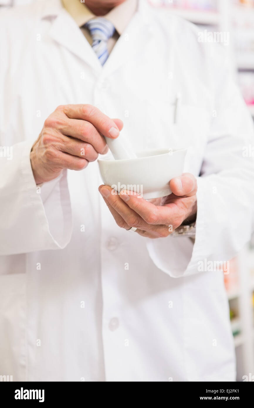 Mid section of pharmacist mixing medicine Stock Photo - Alamy