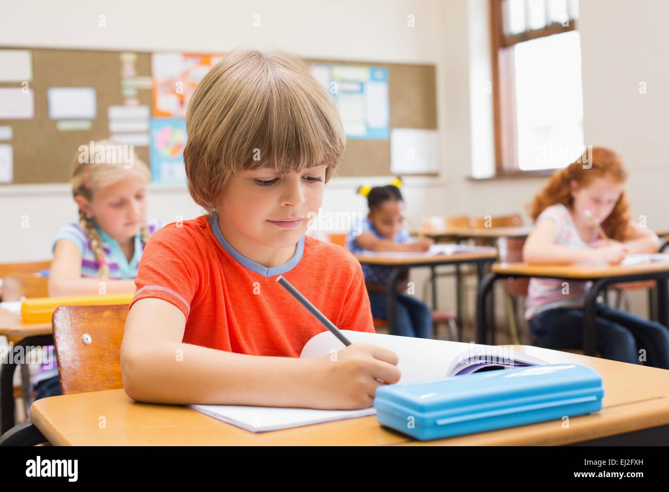 Thoughtful boy writing in notebook hi-res stock photography and images ...
