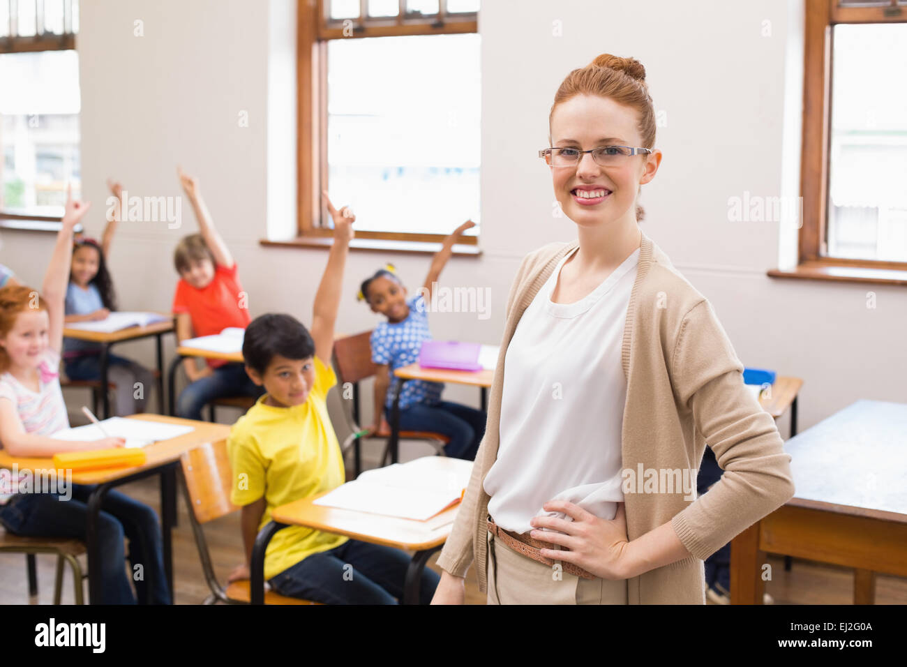 Pupils raising their hands during class Stock Photo - Alamy