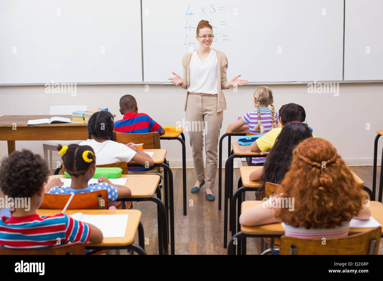 Teacher giving a mathematics lesson in classroom Stock Photo - Alamy