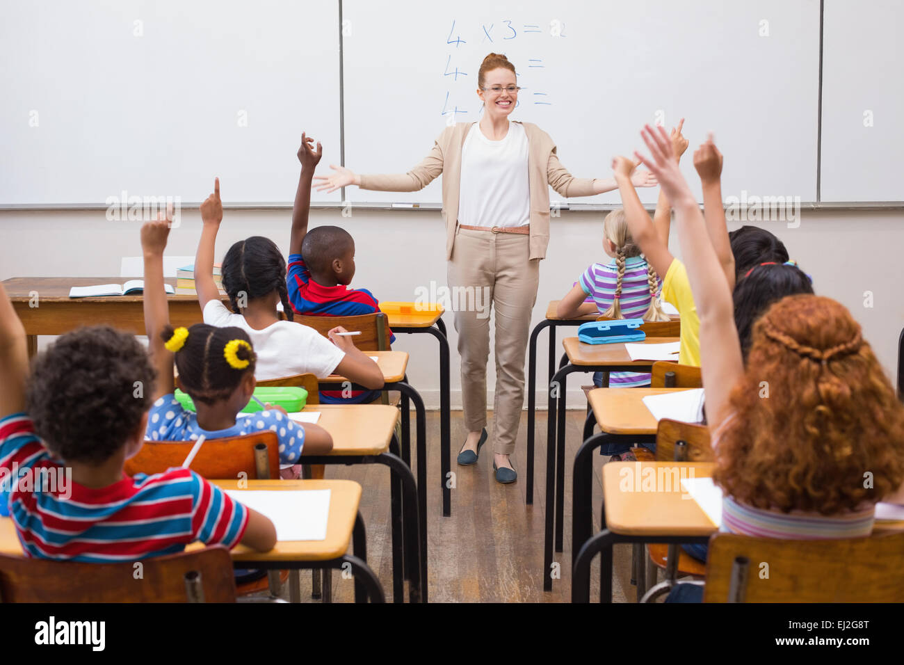Teacher giving a mathematics lesson in classroom Stock Photo - Alamy