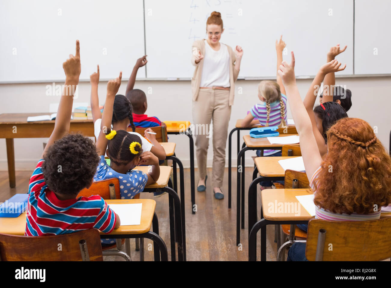 Teacher giving a mathematics lesson in classroom Stock Photo - Alamy