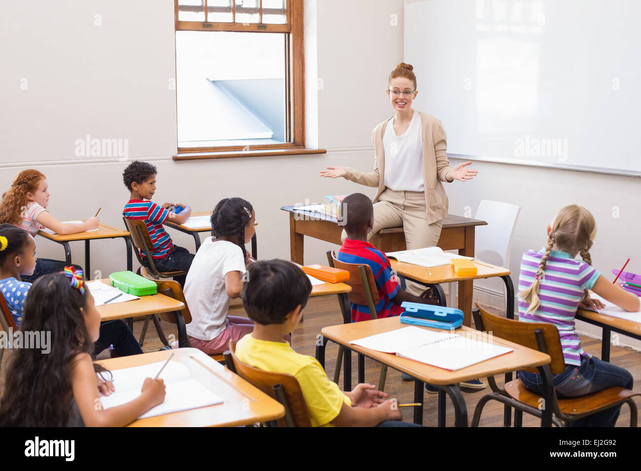 Teacher giving a lesson in classroom Stock Photo - Alamy