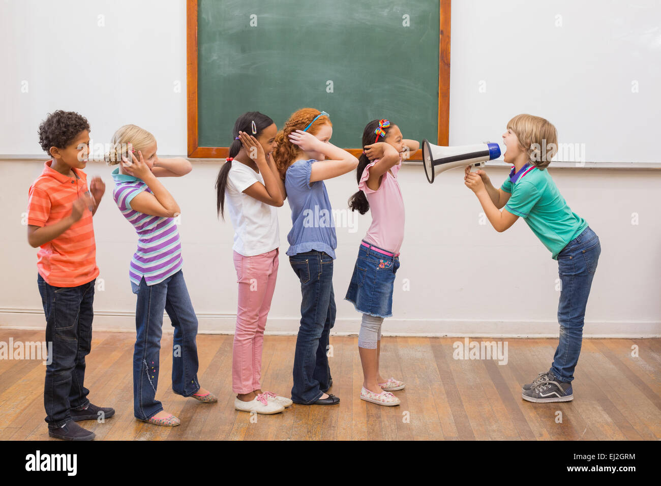 Cute pupil shouting in classroom Stock Photo - Alamy