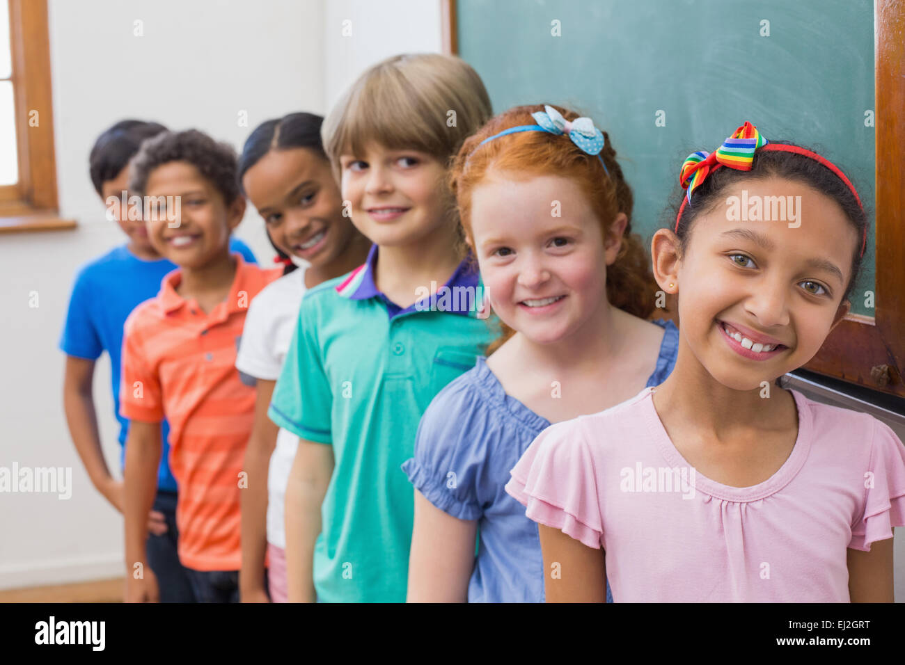Smiling pupils in classroom Stock Photo - Alamy