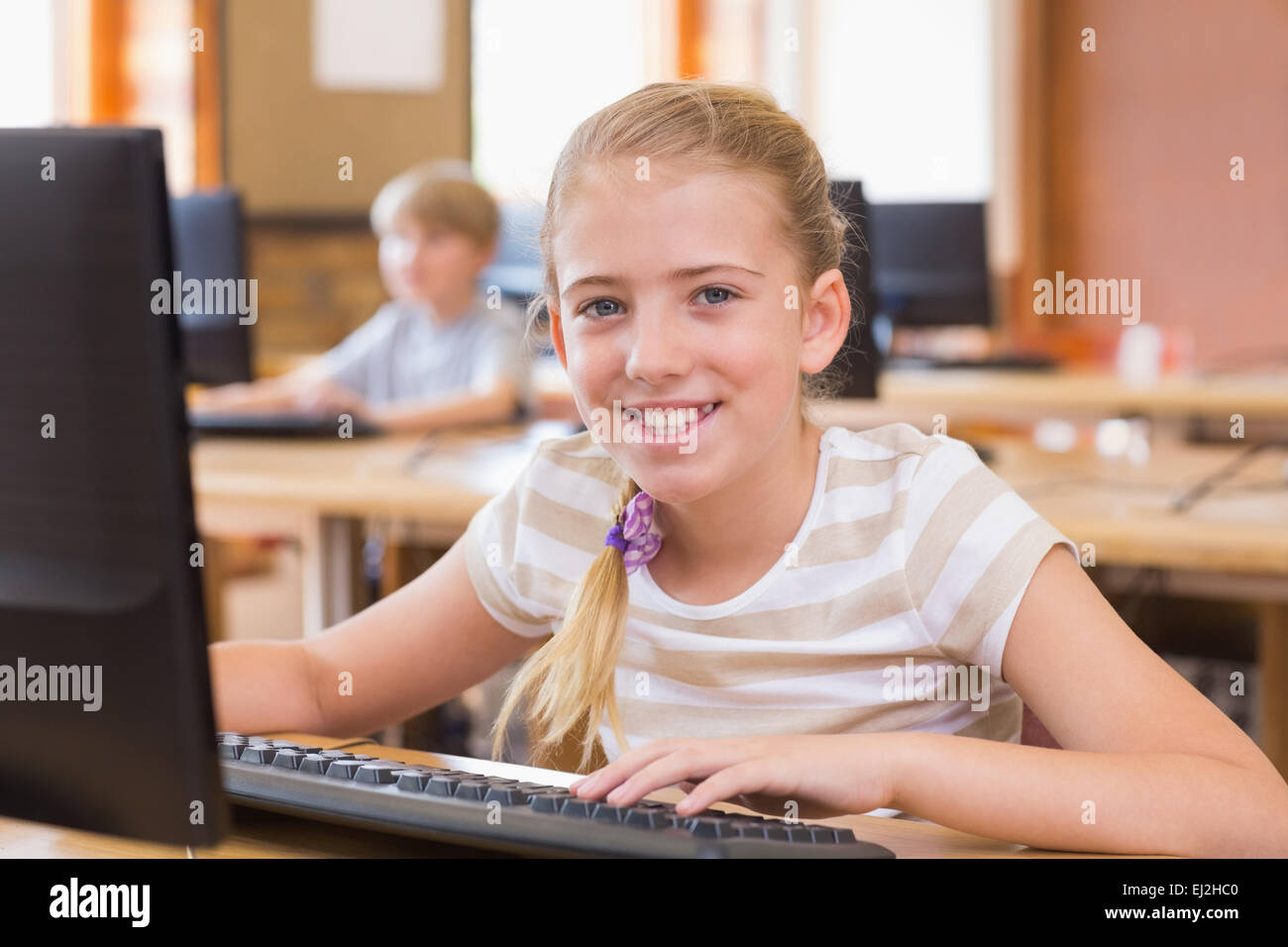 Cute pupil in computer class Stock Photo - Alamy