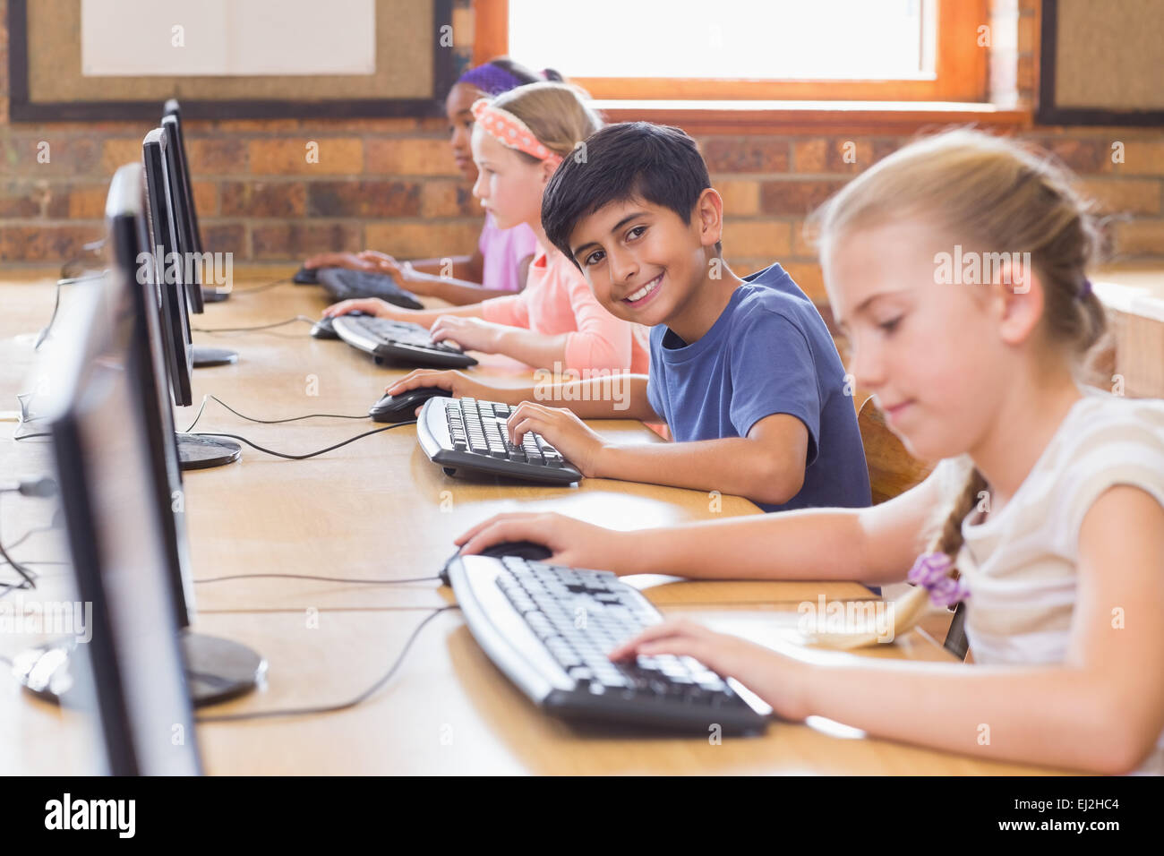 Cute pupils in computer class Stock Photo - Alamy