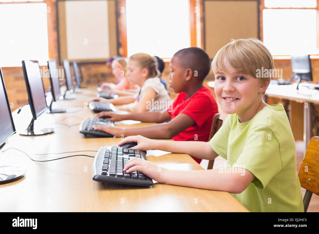 Cute pupils in computer class Stock Photo - Alamy