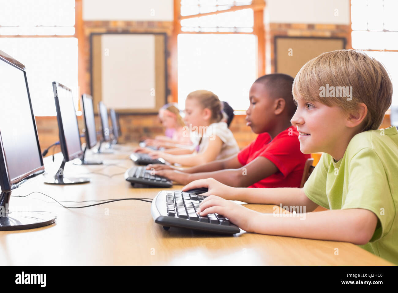 Cute pupils in computer class Stock Photo - Alamy